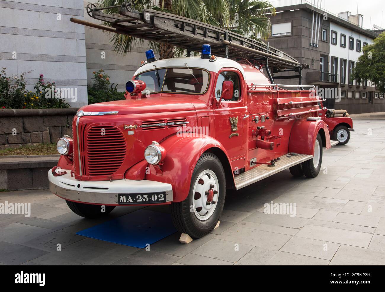 An old red fire engine on display during a classic vehicle rally in ...