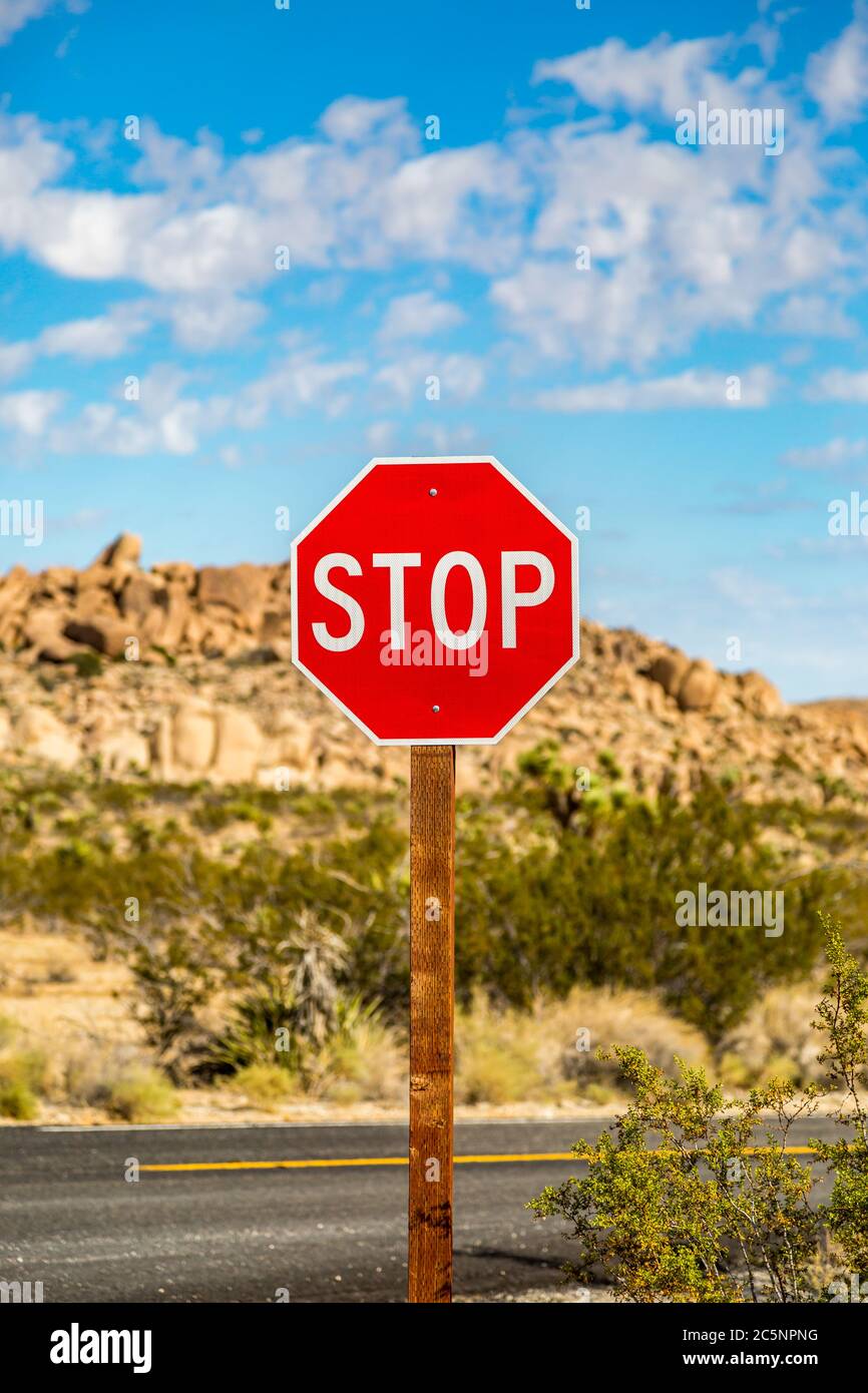 A STOP sign in California with a rocky landscape behind Stock Photo - Alamy