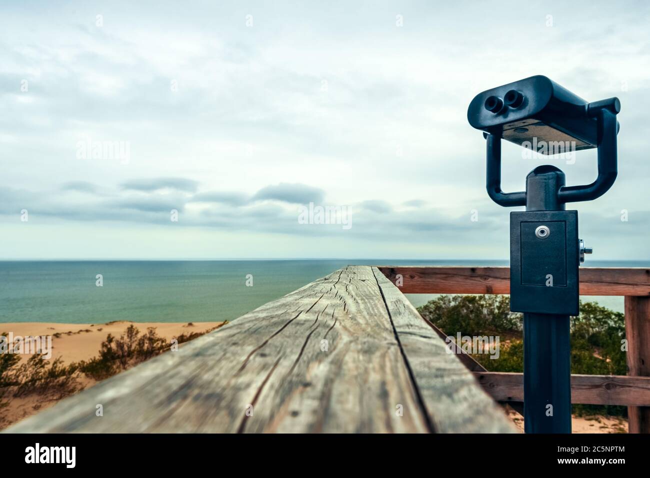 Binoculars for the observation deck on the beach at the wooden railing ...