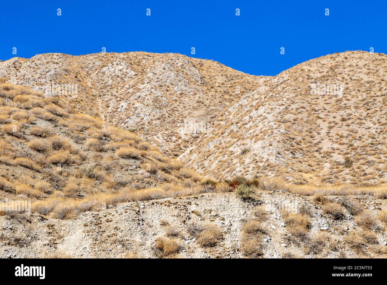Rugged hills in the Californian desert, with a blue sky overhead Stock ...