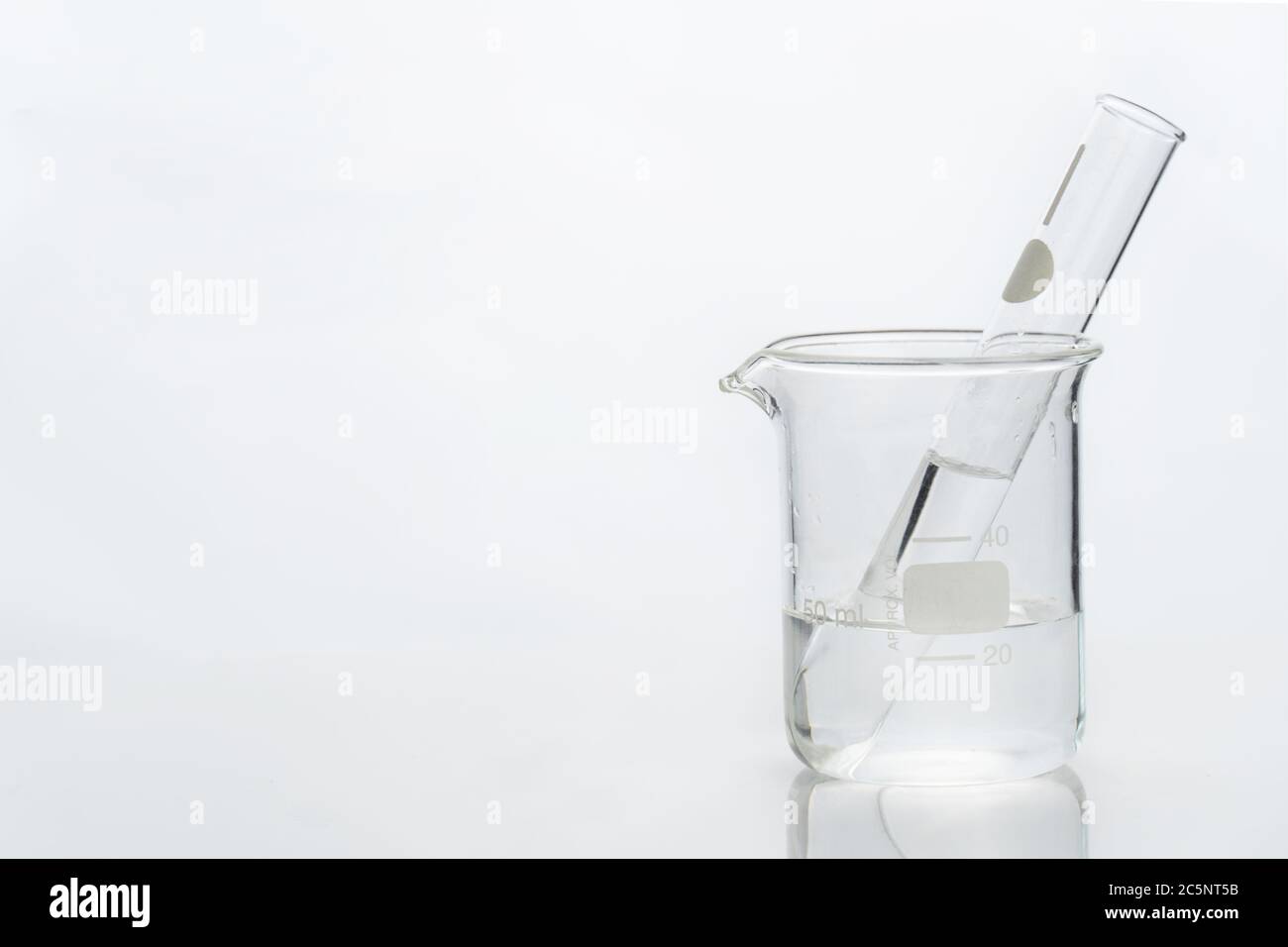clear water in test tube and glass science beaker in white chemistry ...