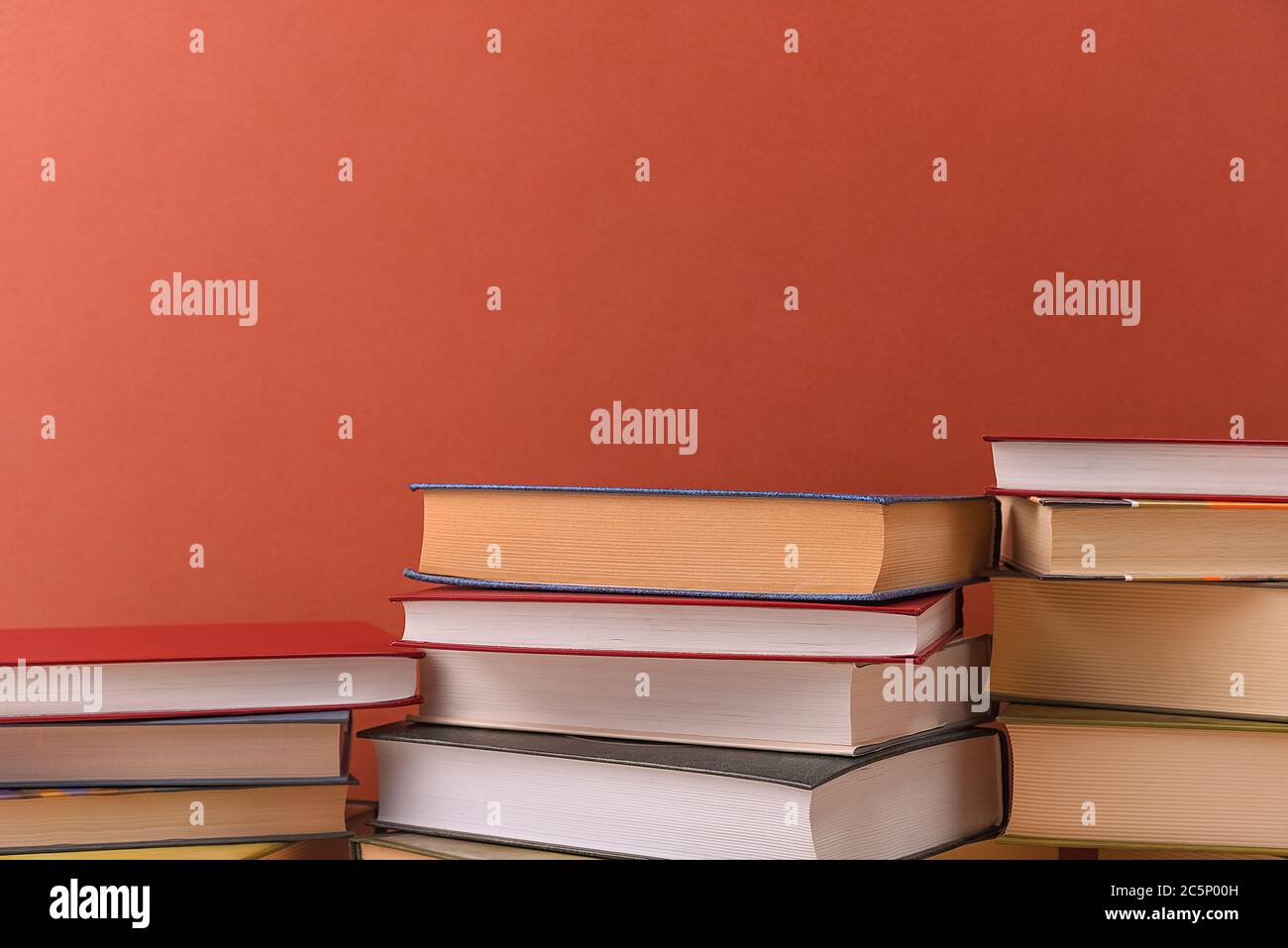 Stacks of books several on a brown background close-up. Hardcover books ...