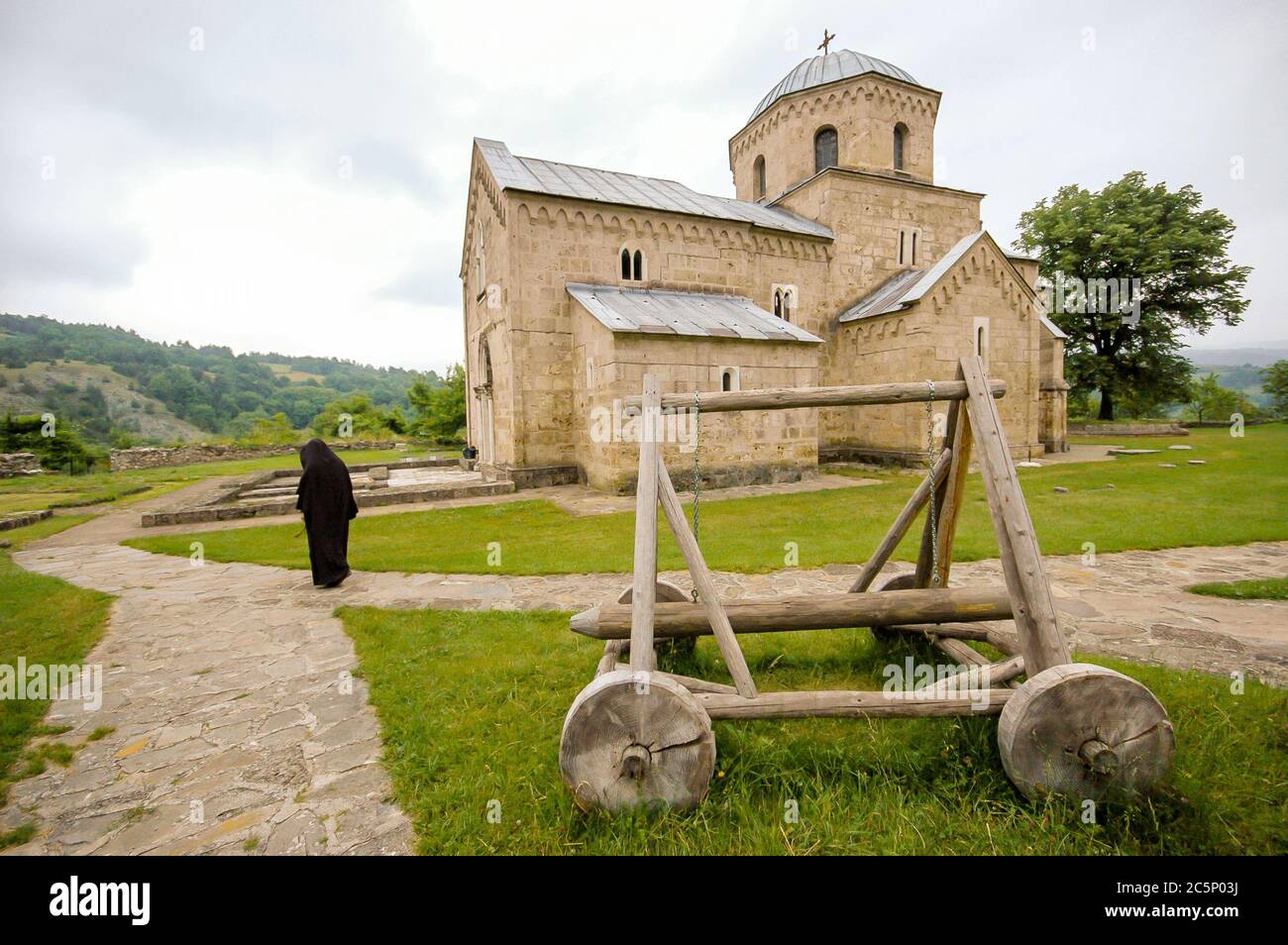 the nun walks the courtyard of the monastery Gradac in Serbia, which is ...