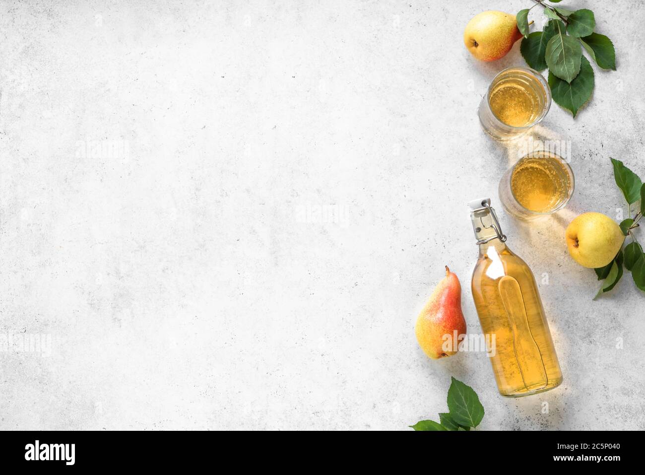 Pear cider drink or fermented fruit drink in glasses and bottle and ...