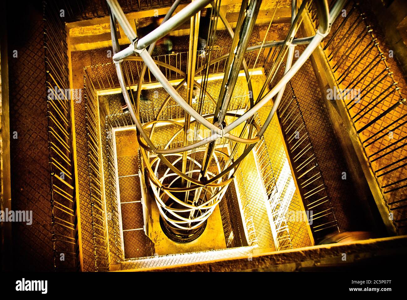Metal spiral staircase and curved structure of elevator Stock Photo - Alamy