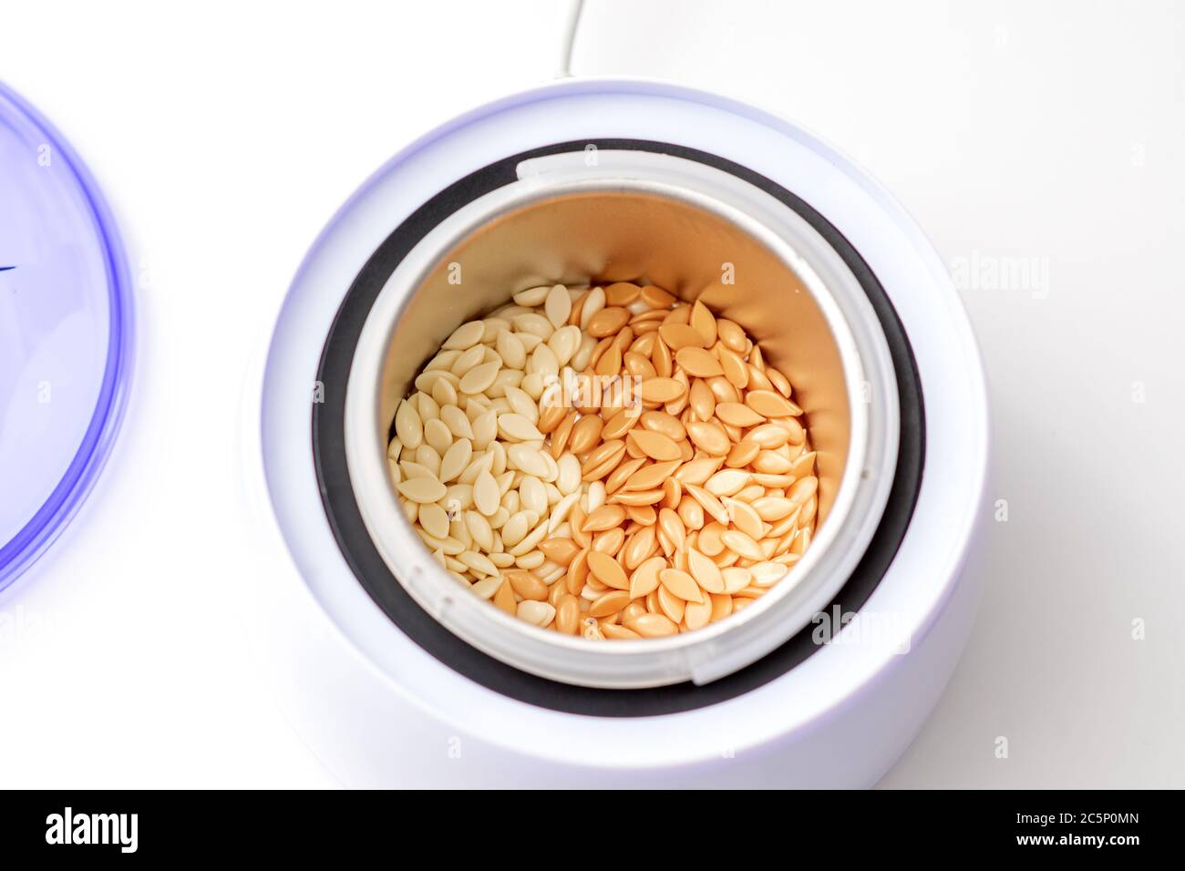 Electric wax warmer or wax heater with wax drops inside while heating ...