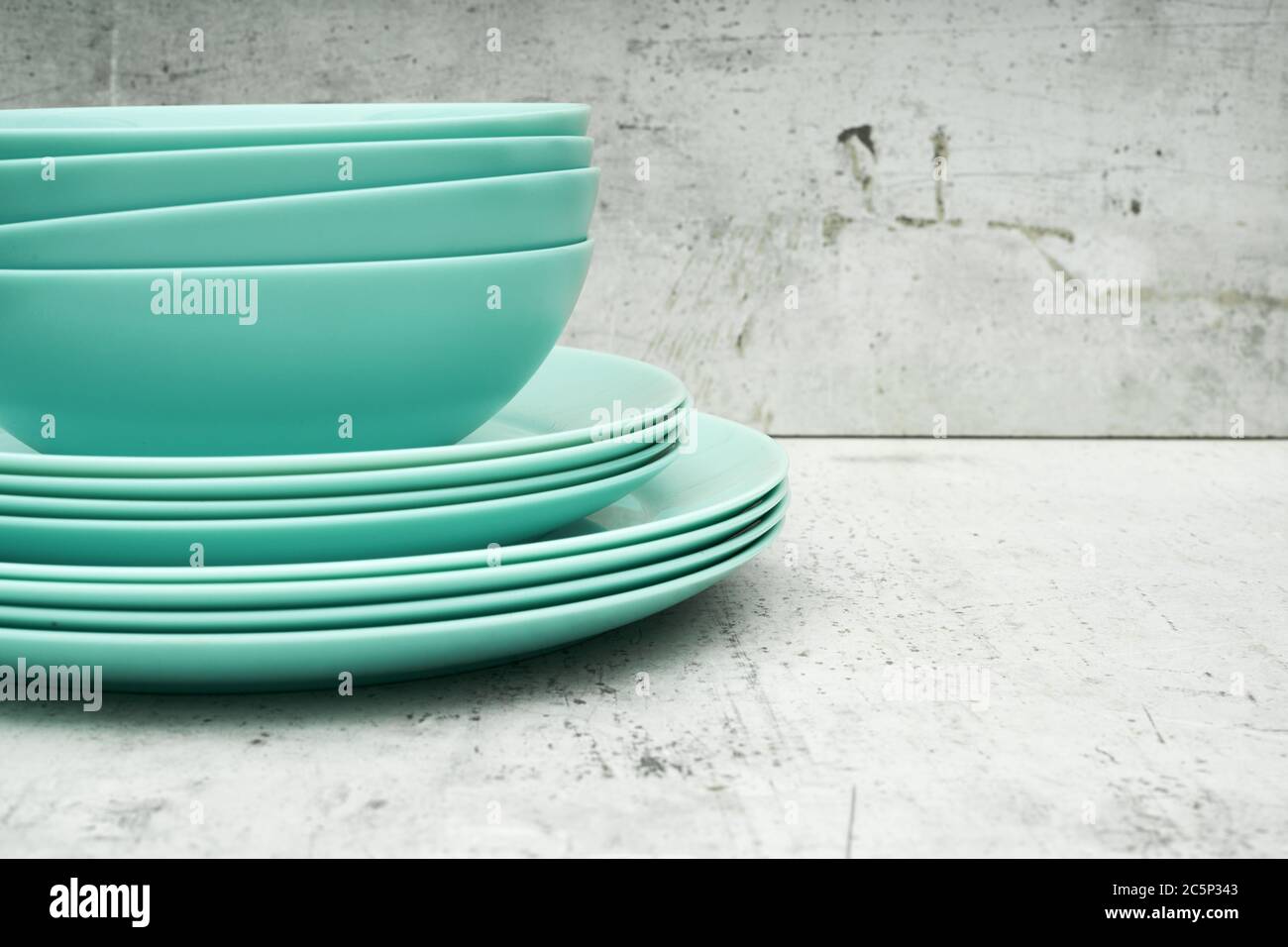 A stack of dishes on a light background. Glass set of dishes for the ...