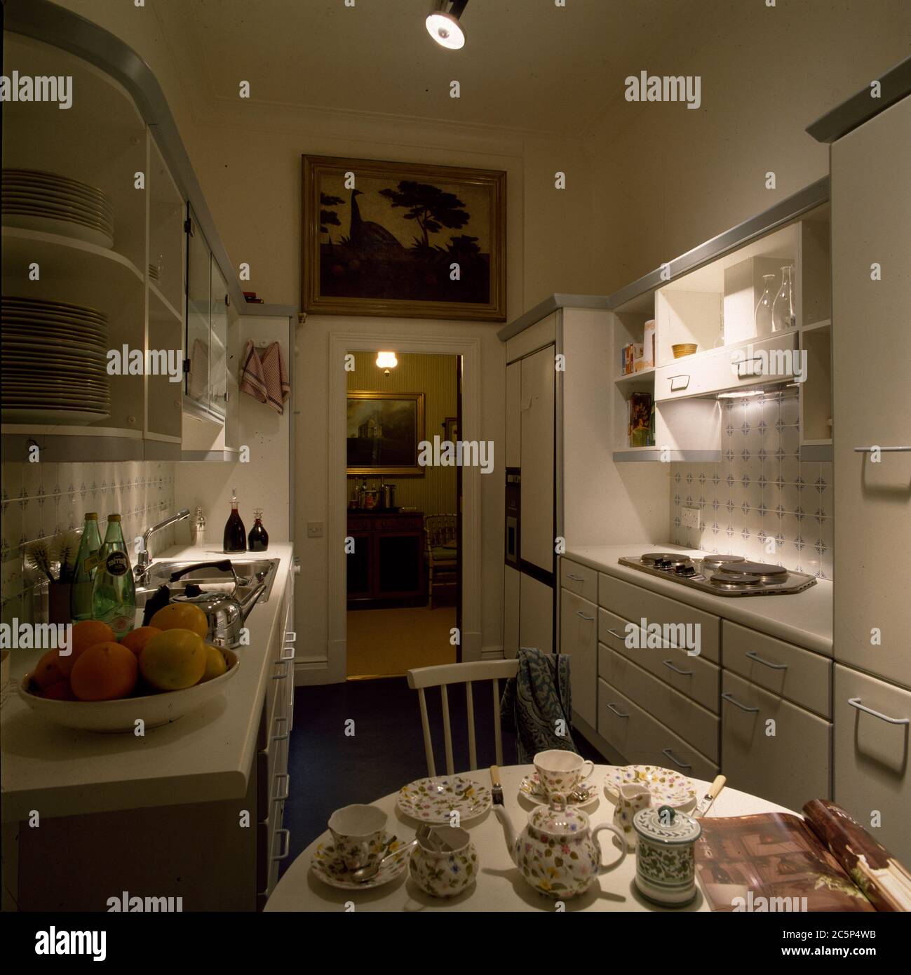 Small kitchen with round table set for breakfast Stock Photo - Alamy