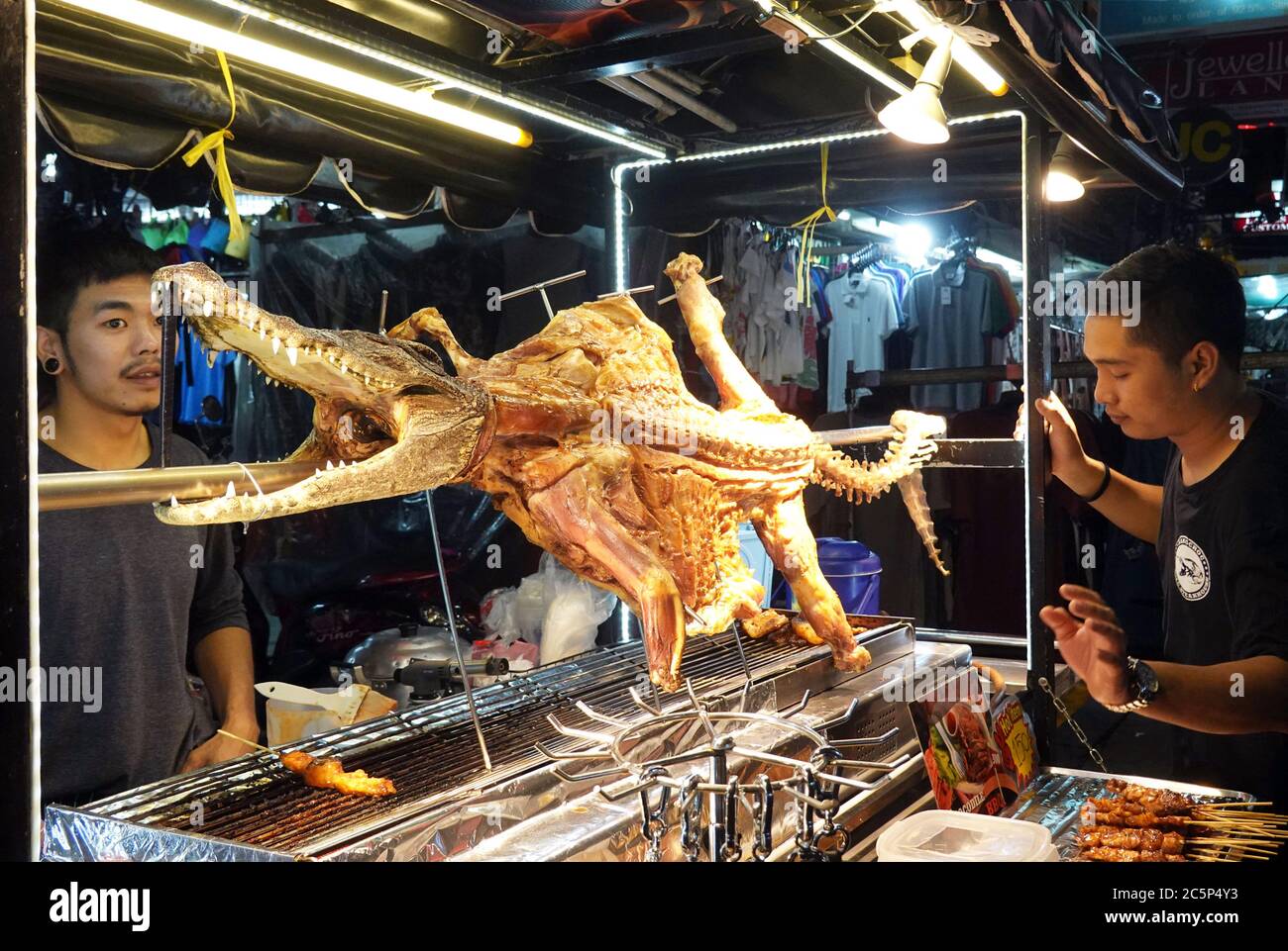 Bangkok, Thailand. 21st Oct, 2019. An alligator on a spit over a grill ...