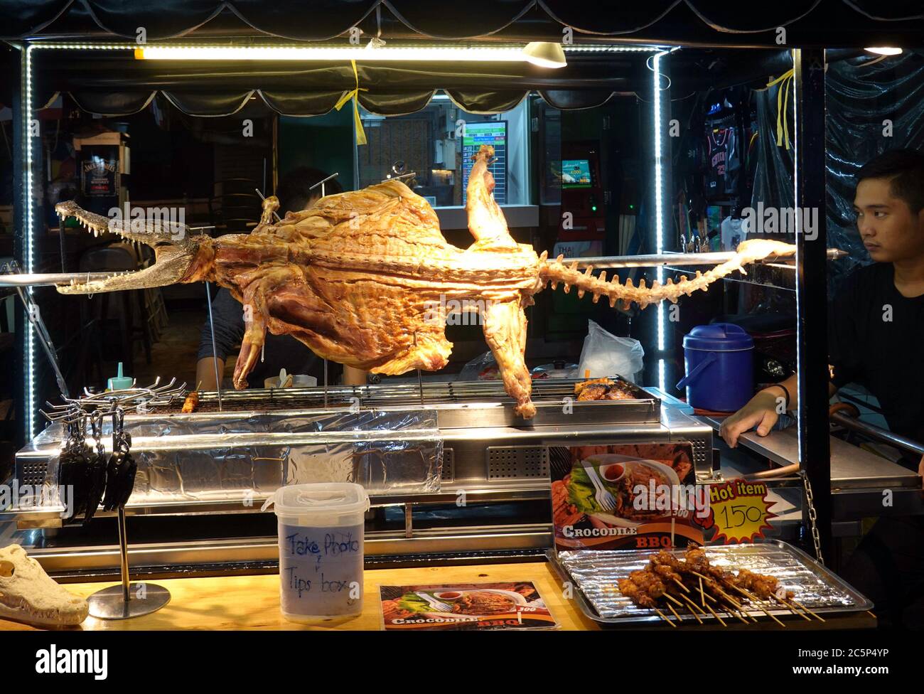 Bangkok, Thailand. 21st Oct, 2019. An alligator on a spit over a grill ...