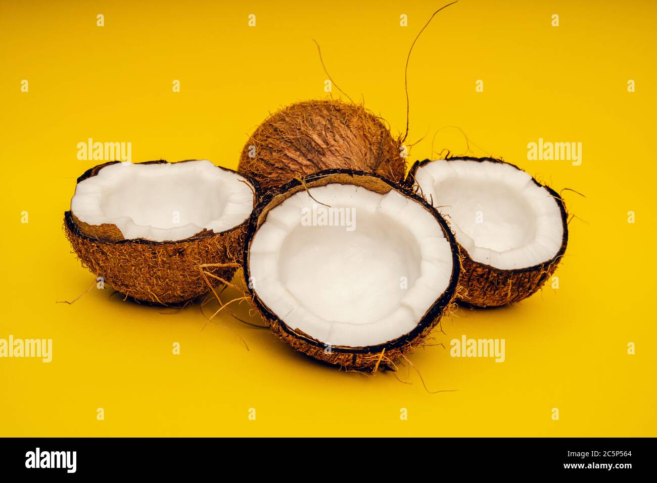 Parts of coconut on a colored background. Close up. Fresh ripe coconut ...