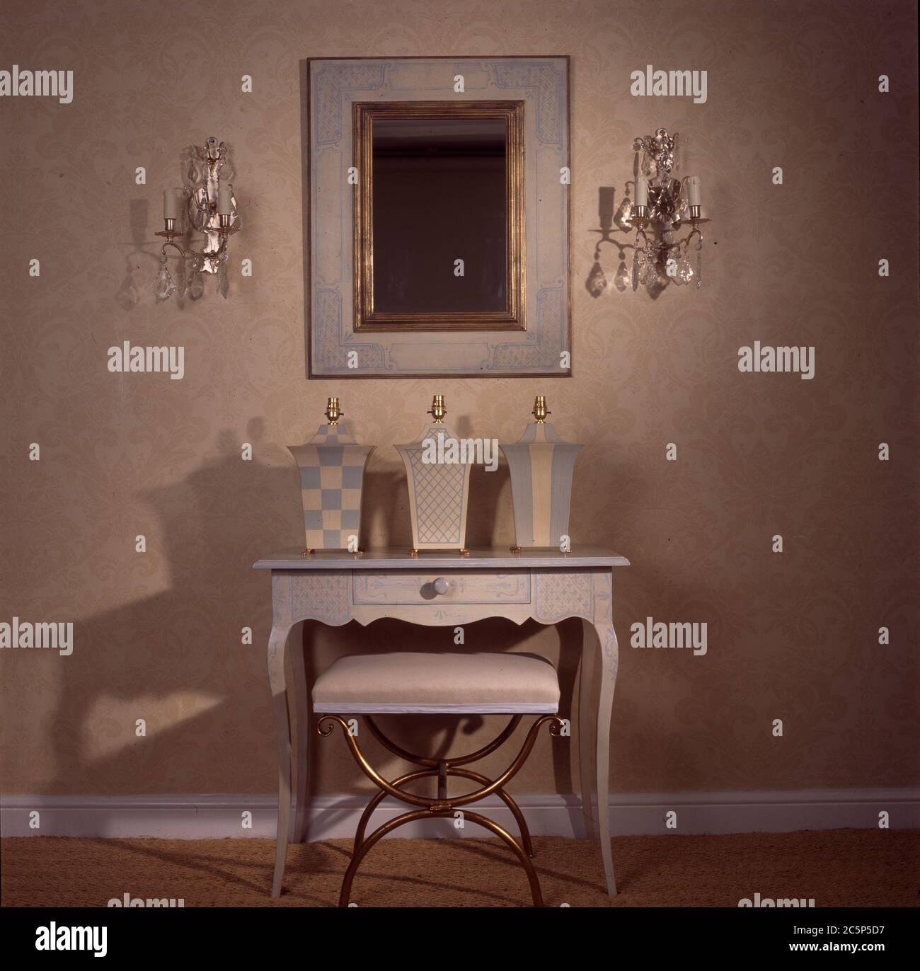 Landing table with mirror and wall lights Stock Photo - Alamy