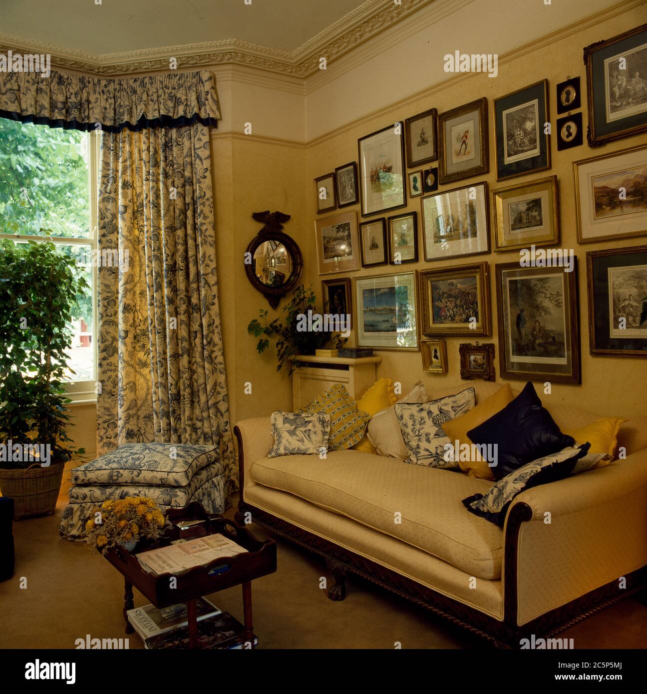 Traditional livingroom with sofa and wall of framed pictures Stock ...