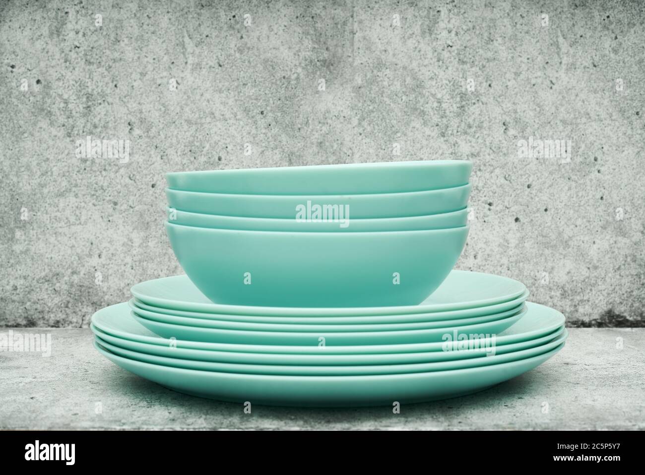 A stack of dishes on a light background. Glass set of dishes for the ...