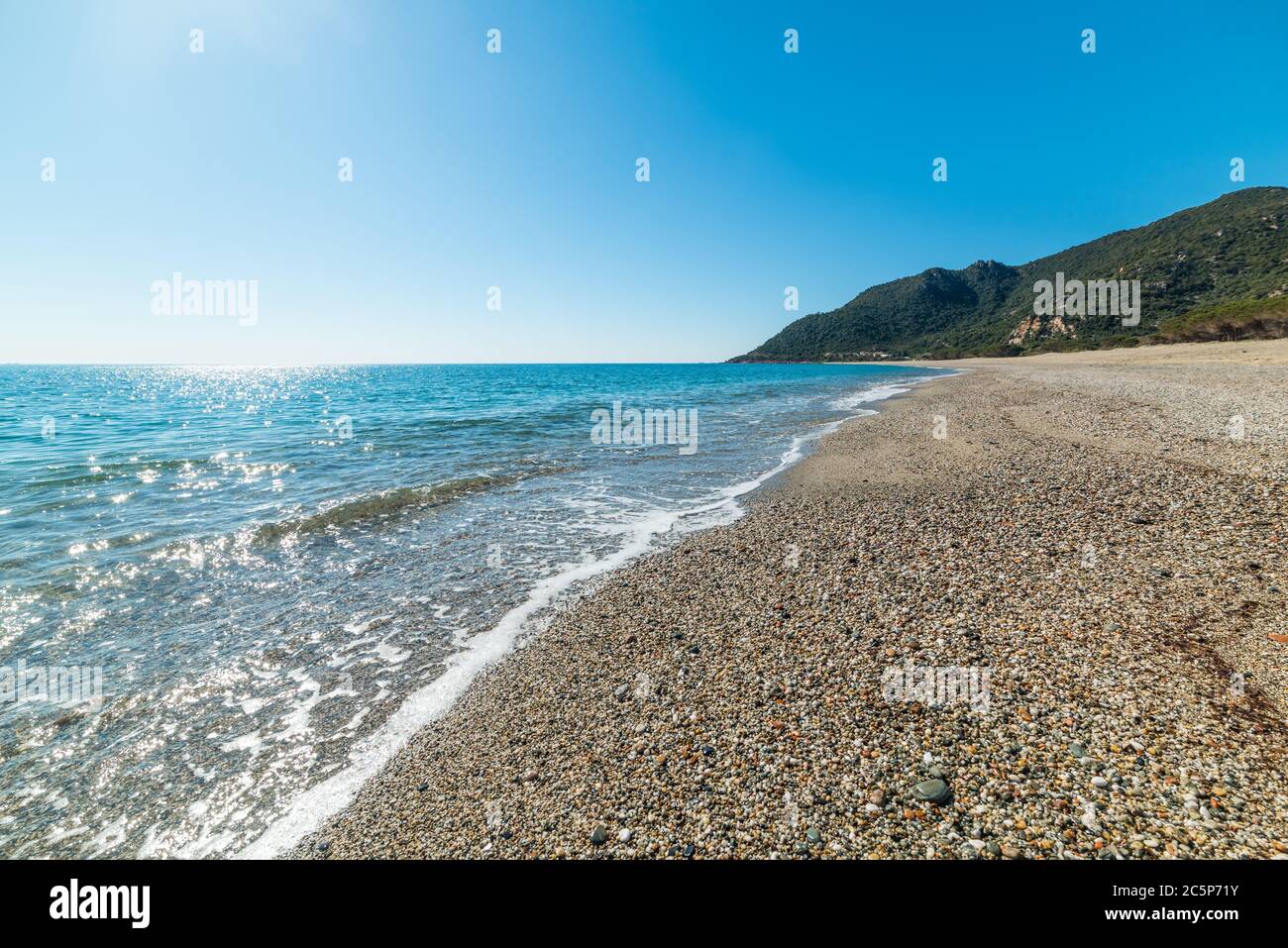 Sun shining over Perdepera beach on a summer day Stock Photo - Alamy