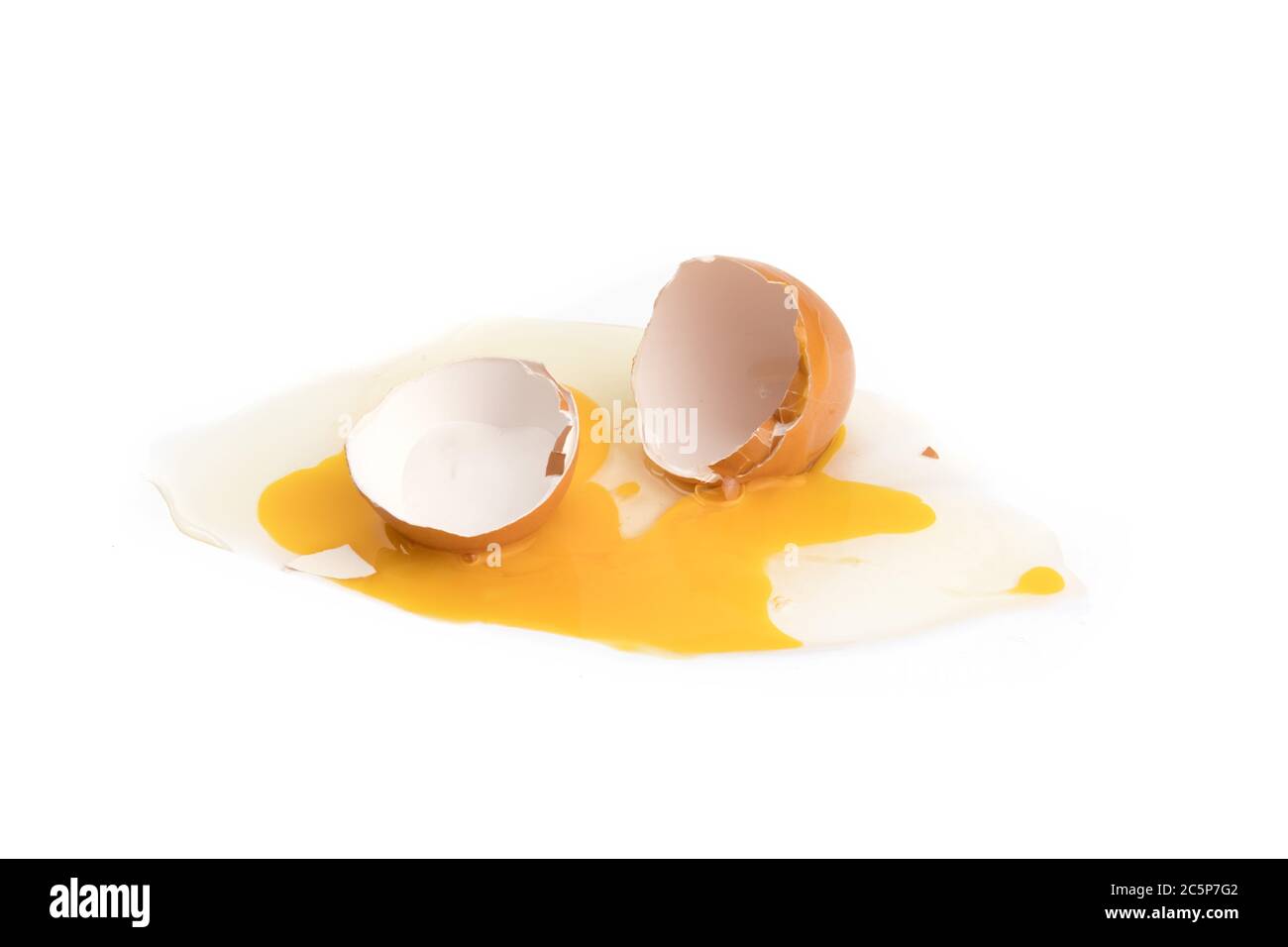 a broken brown egg with yolk running around the eggshell isolated on ...