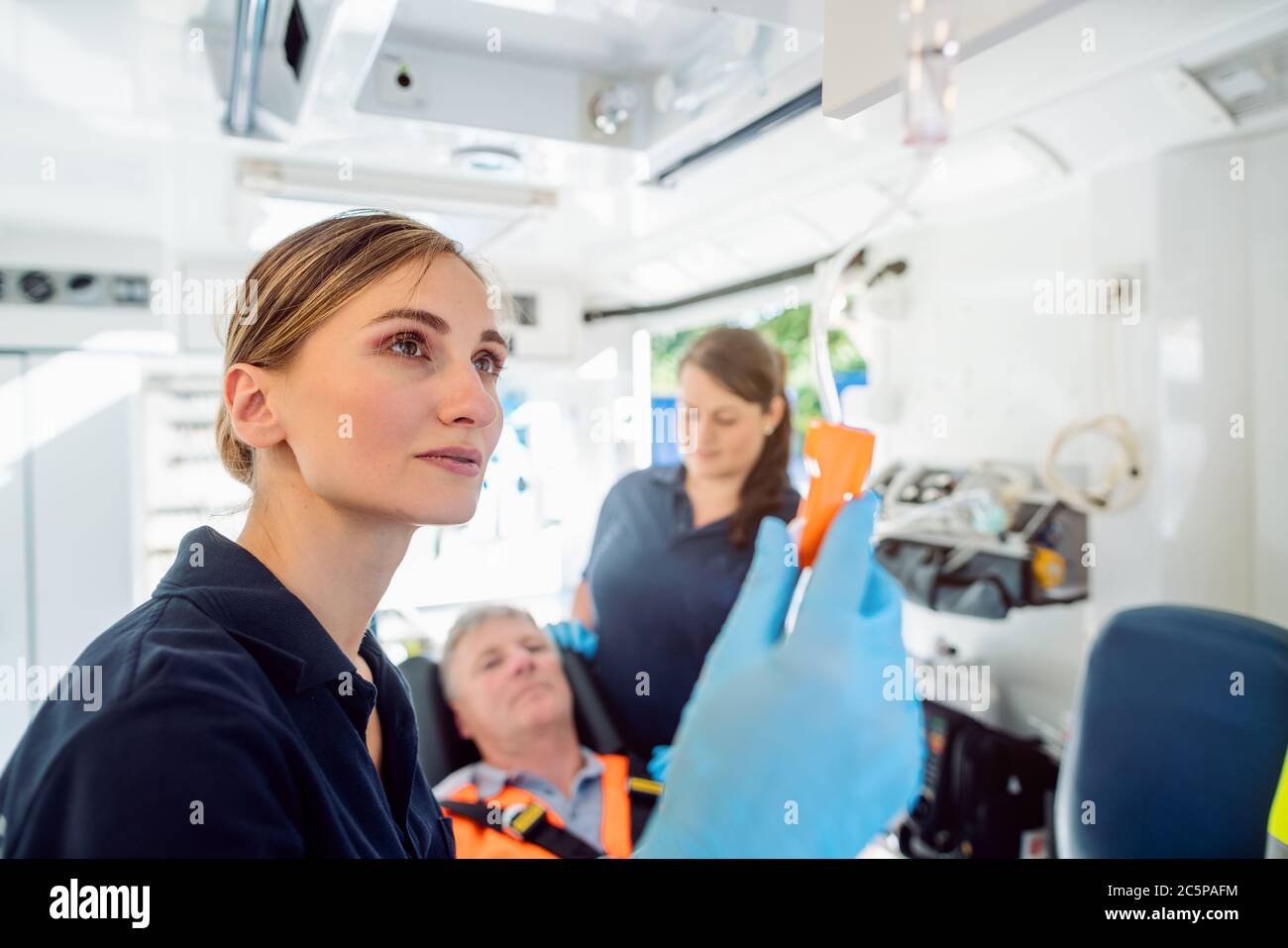 Paramedic looking after the drop injection in an ambulance Stock Photo ...