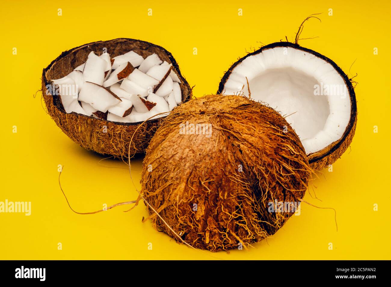 Parts of coconut on a colored background. Close up. Fresh ripe coconut ...