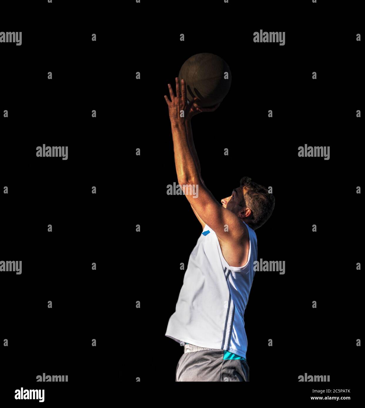 Basketball player jump seen from the right side isolated on black ...