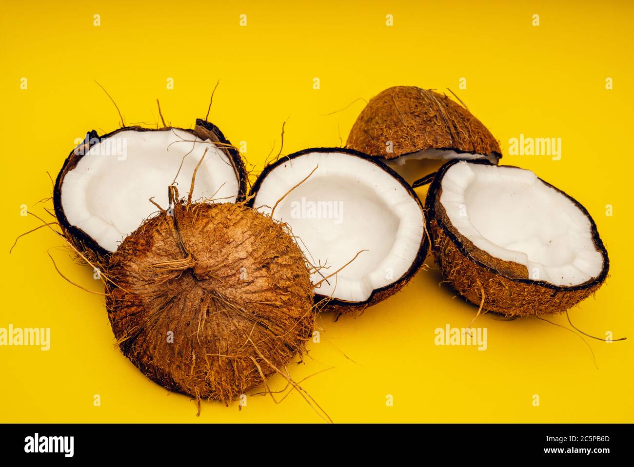 Parts of coconut on a colored background. Close up. Fresh ripe coconut ...
