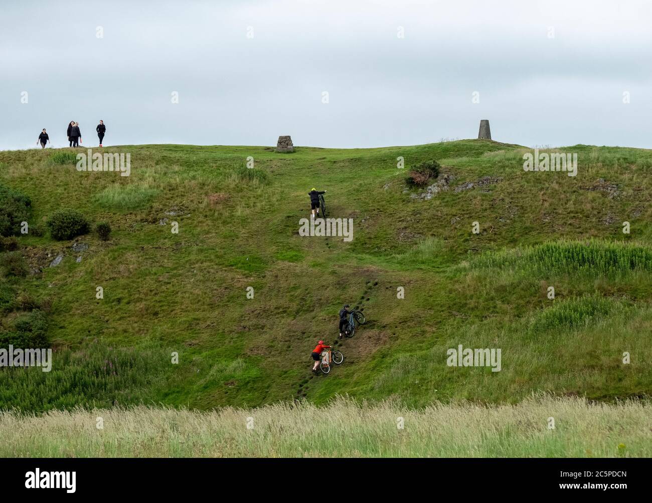 Cyclists climbing to the top of Dechmont Law, Livingston, West Lothian ...