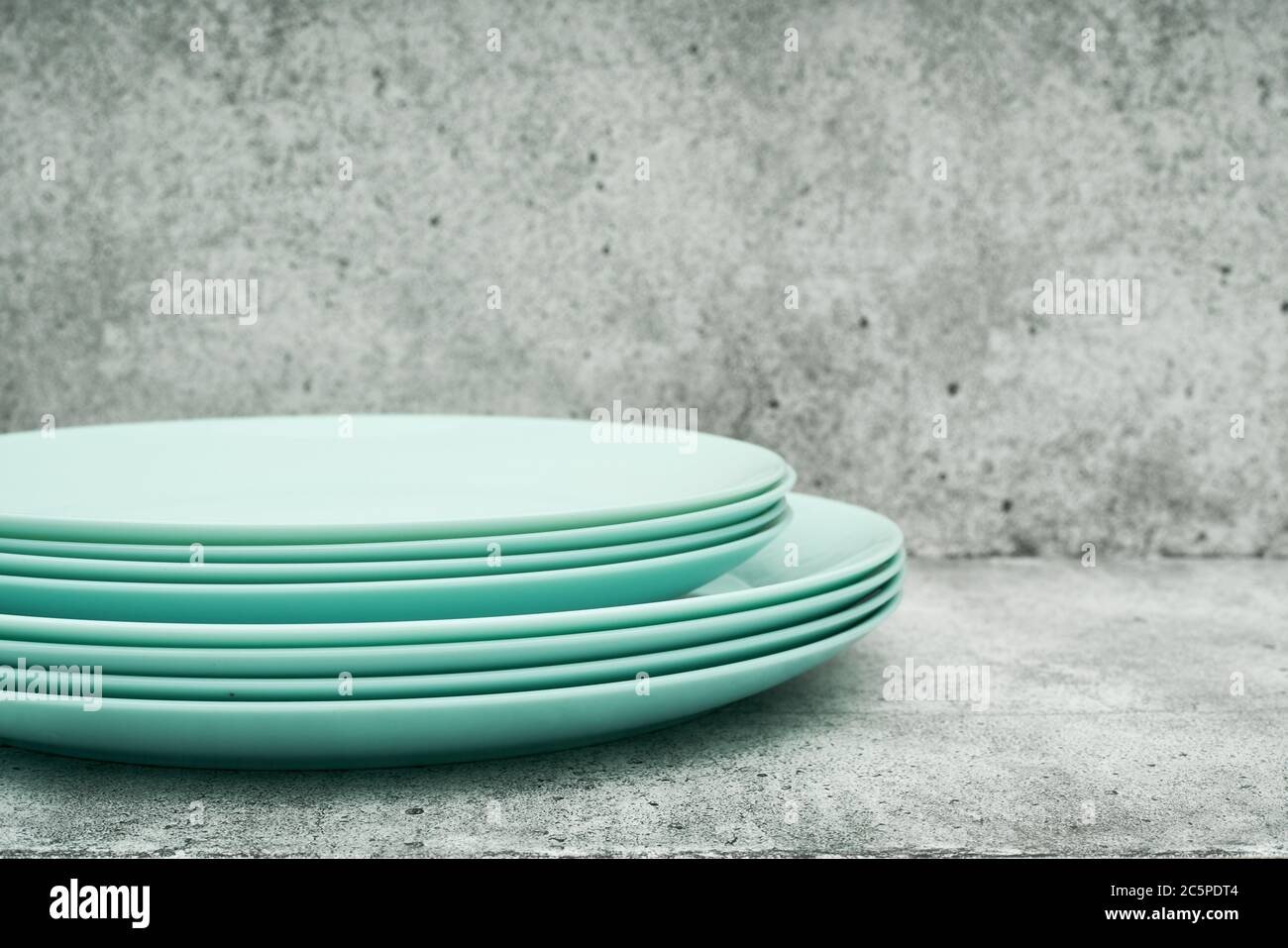 A stack of dishes on a light background. Glass set of dishes for the ...