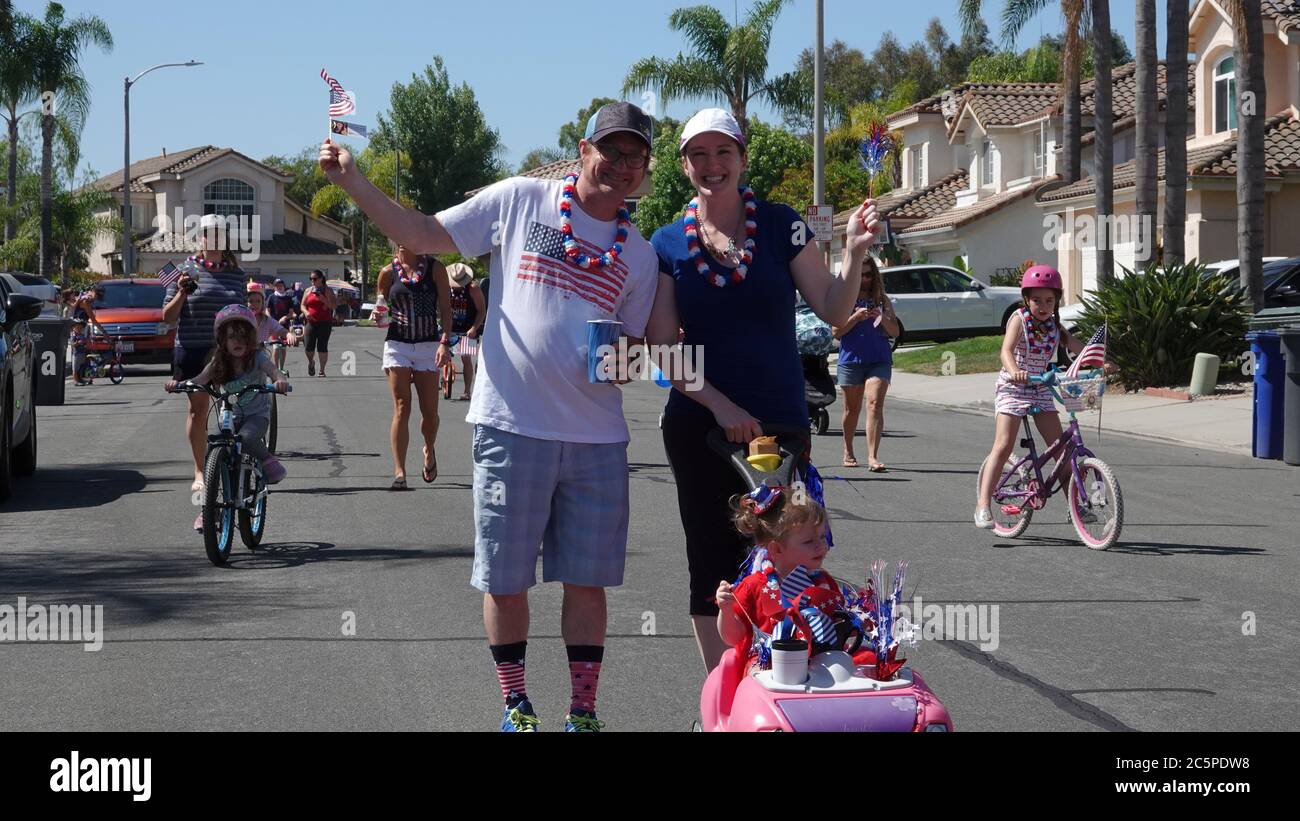 Families participate in a small neighborhood parade celebrating July ...