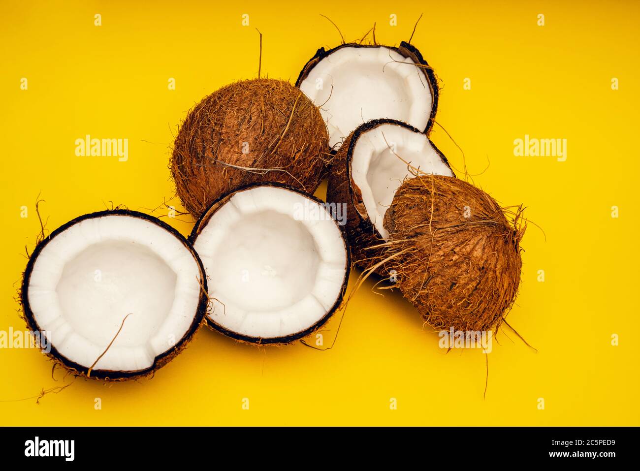 Parts of coconut on a colored background. Close up. Fresh ripe coconut ...