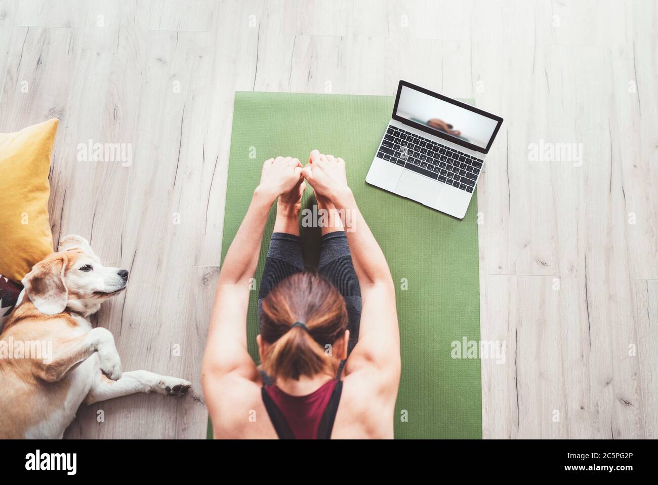 Top view at fit sporty healthy woman sit on mat in Paschimottanasana ...