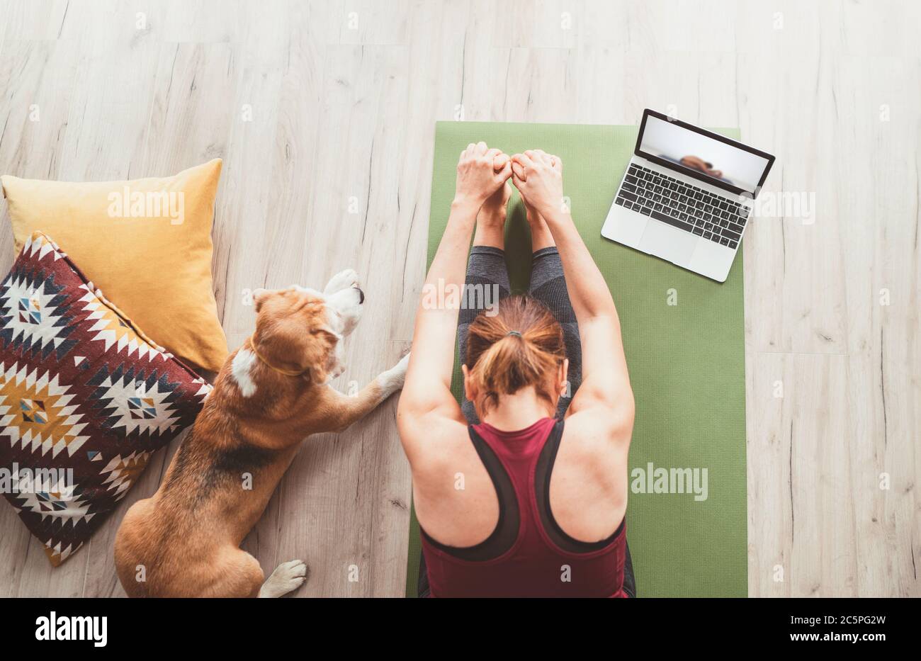 Top view at fit sporty healthy woman sit on mat in Paschimottanasana ...