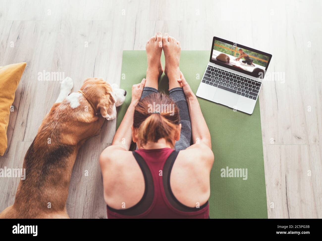 Top view at fit sporty healthy woman sit on mat in Paschimottanasana ...