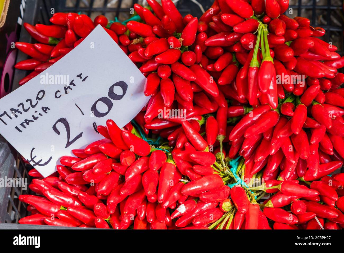 Red spicy peppers on the market with price tag of 2 Euro Stock Photo ...