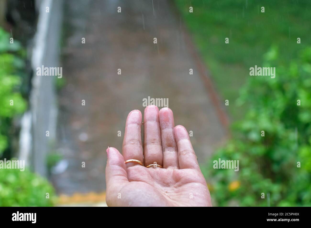Isolated wet human hand with rain drops falling on it Stock Photo - Alamy