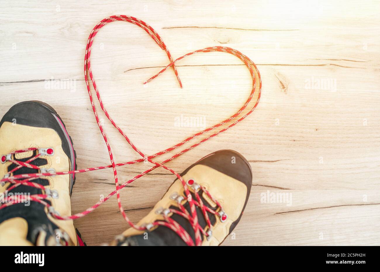 Conceptual image of the pair new trekking boots on the wooden floor ...