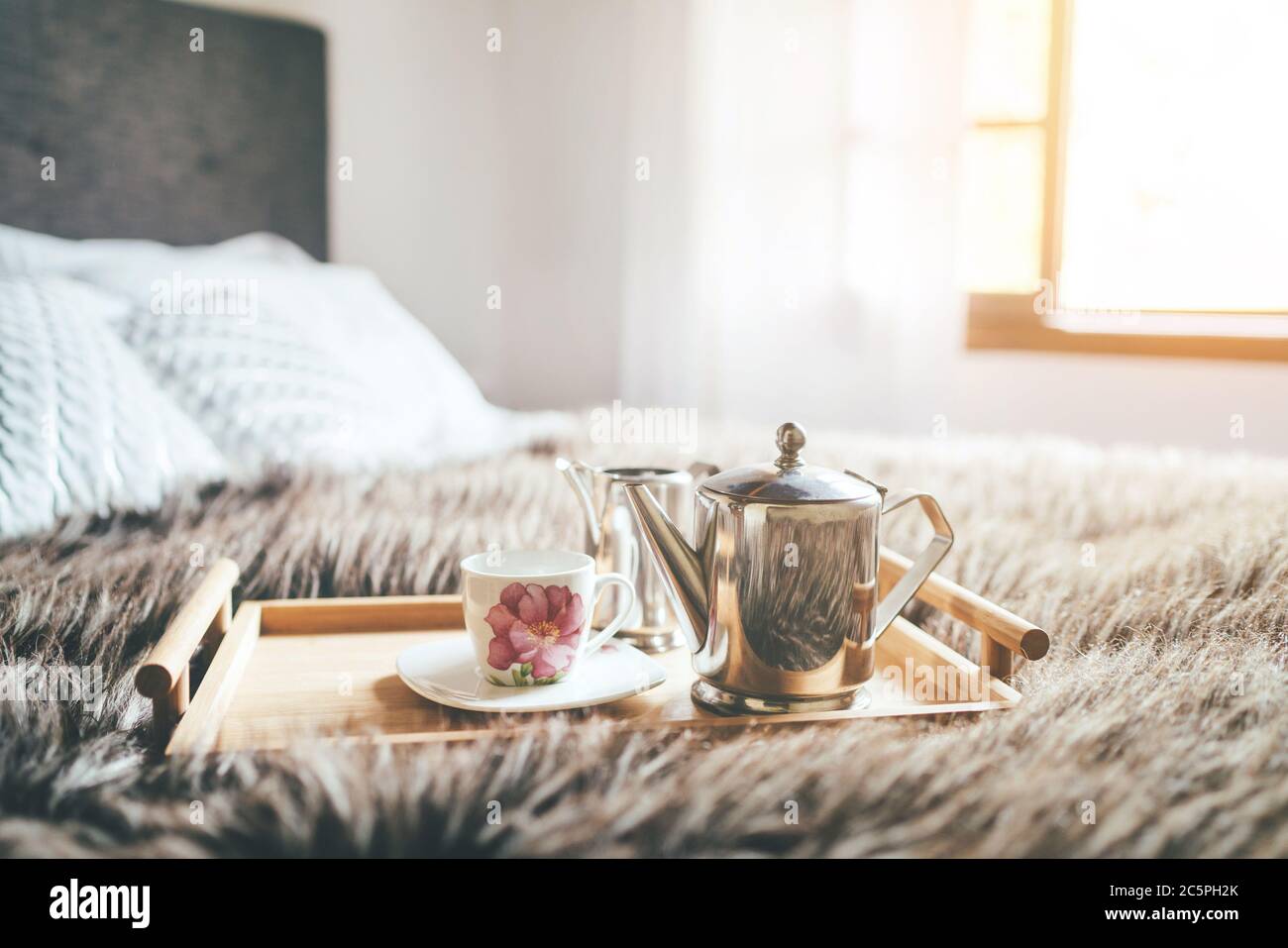 Morning "coffee in bed" still life. Cozy bedroom shot with coffee pot ...