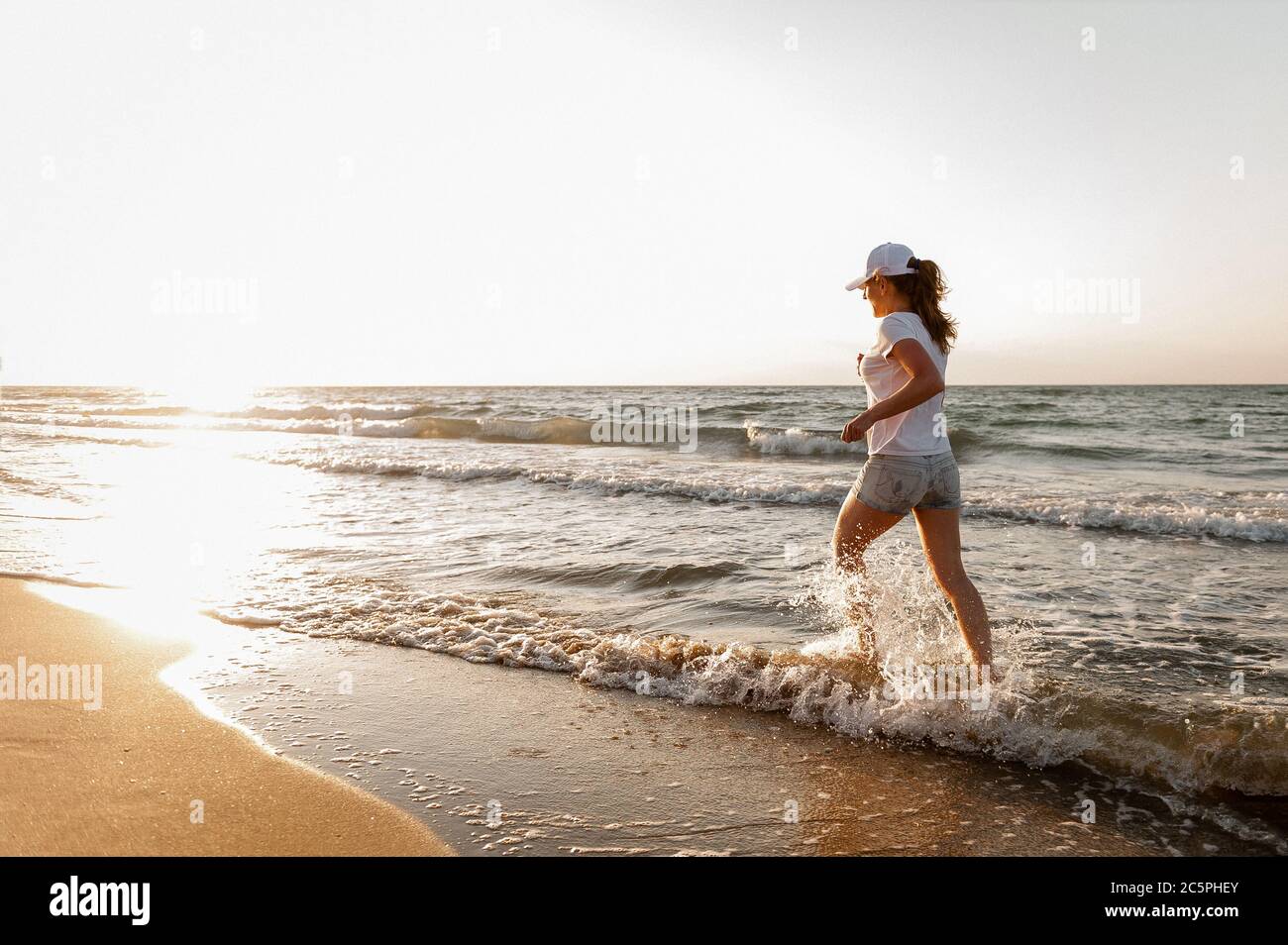 Woman running at the sea hi-res stock photography and images - Alamy