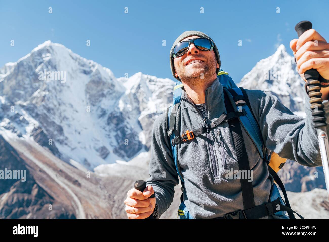 Portrait of smiling Hiker man on Taboche 6495m and Cholatse 6440m peaks ...