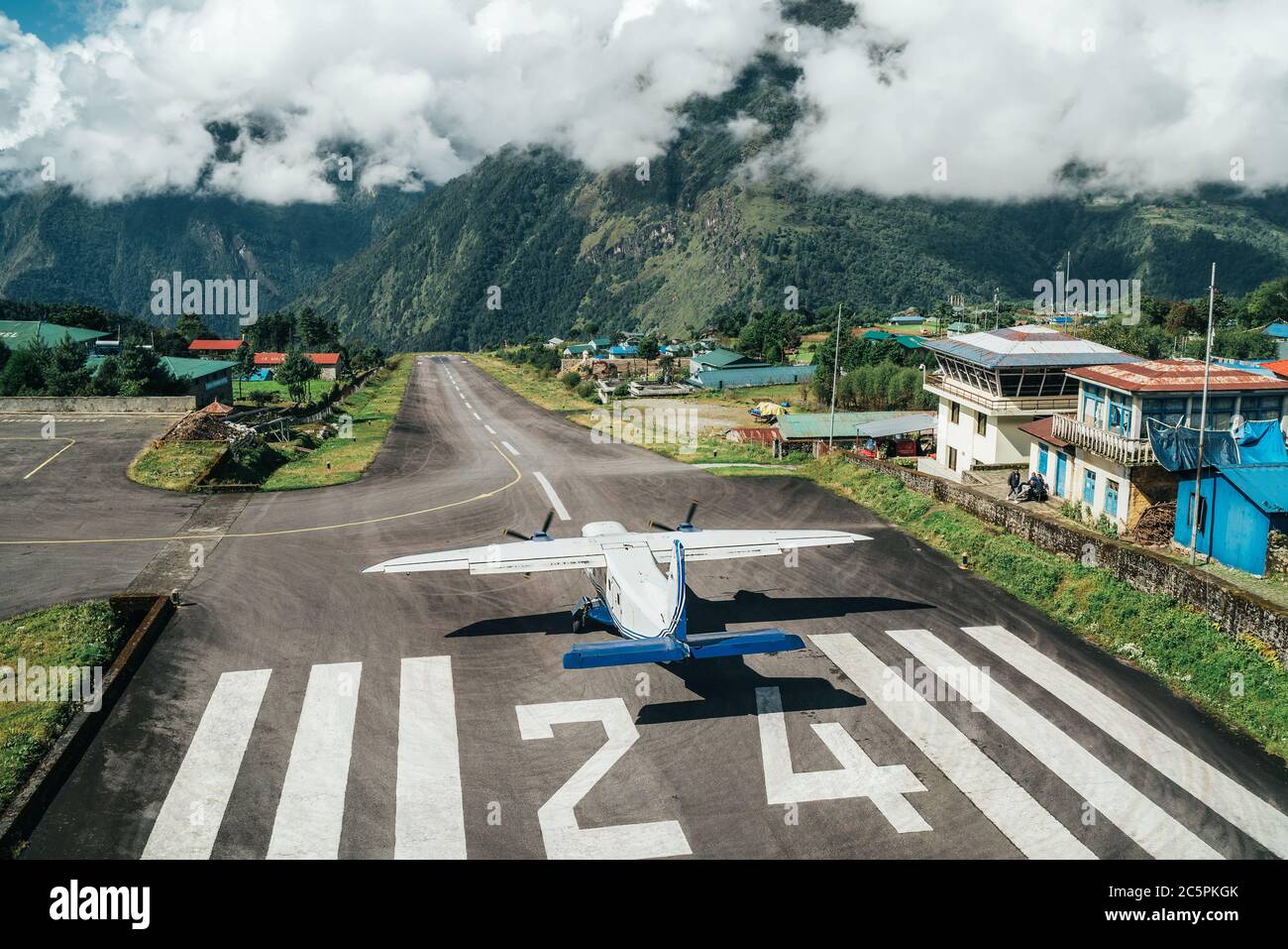Lukla, NEPAL - October 18, 2019: Twin-engine short-range plane landing ...