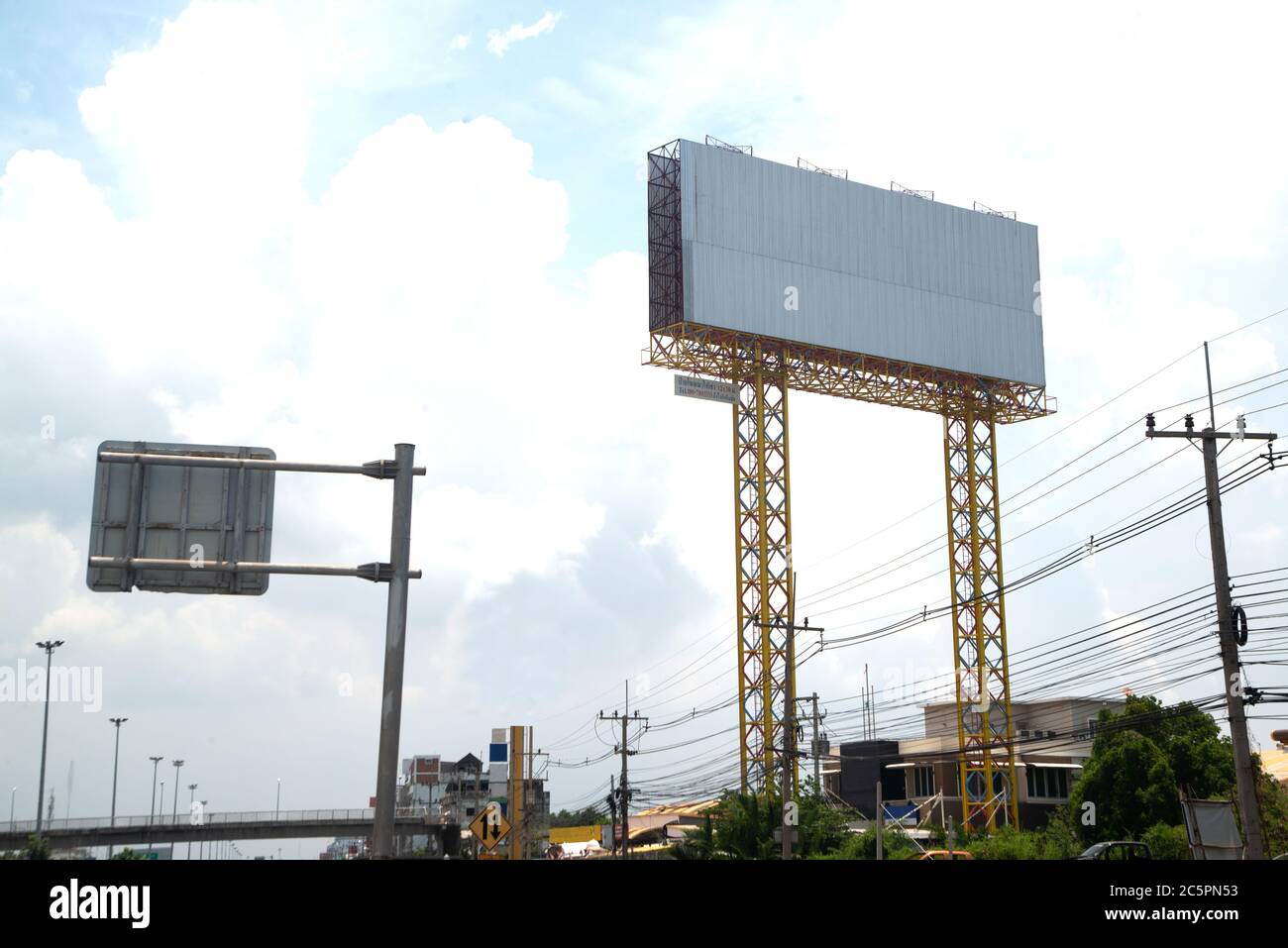 Large gray outdoor advertising signs on the side of the highway or ...