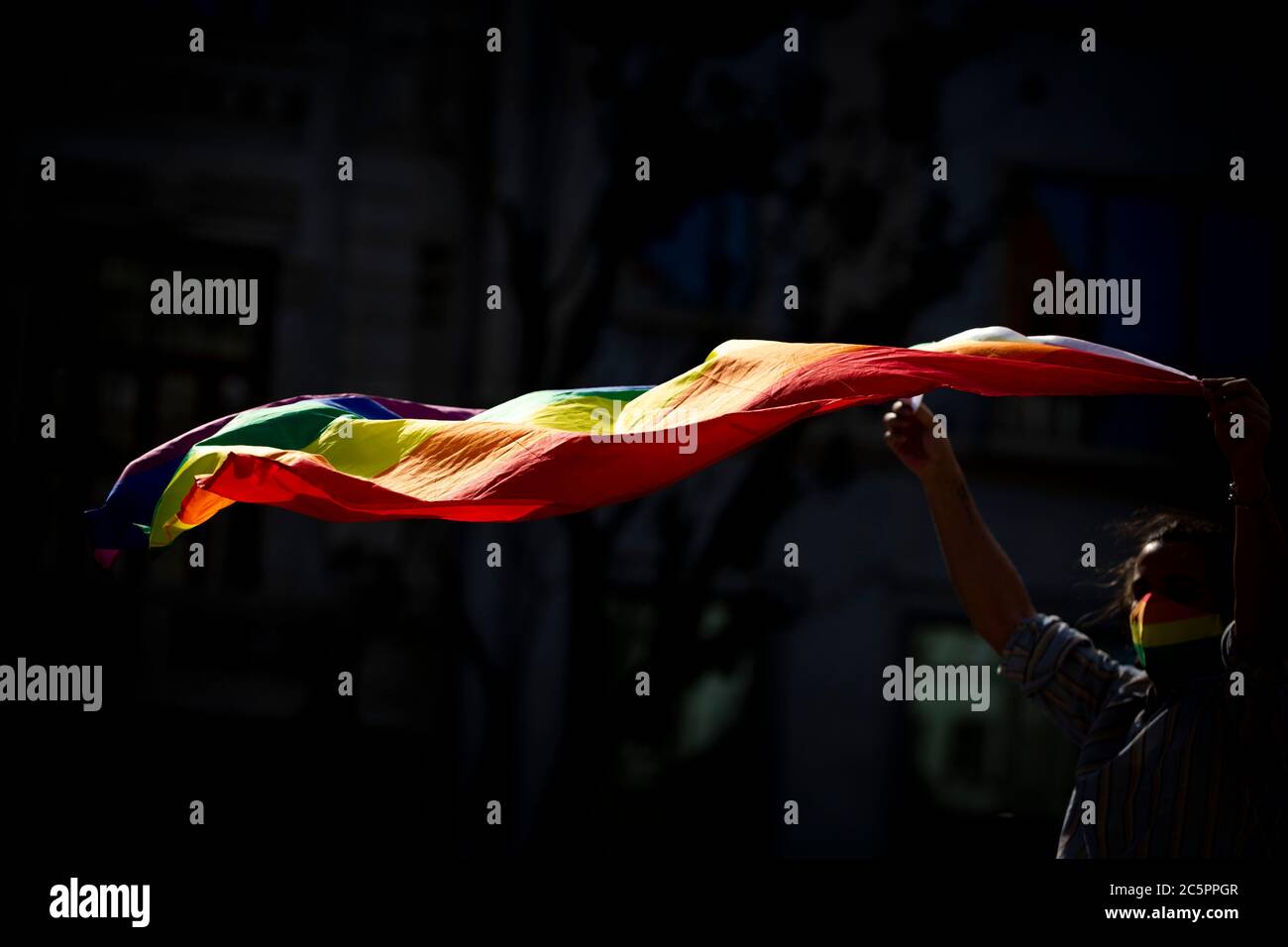A man is seen waving a LGBT flag while participating on the 15th pride ...