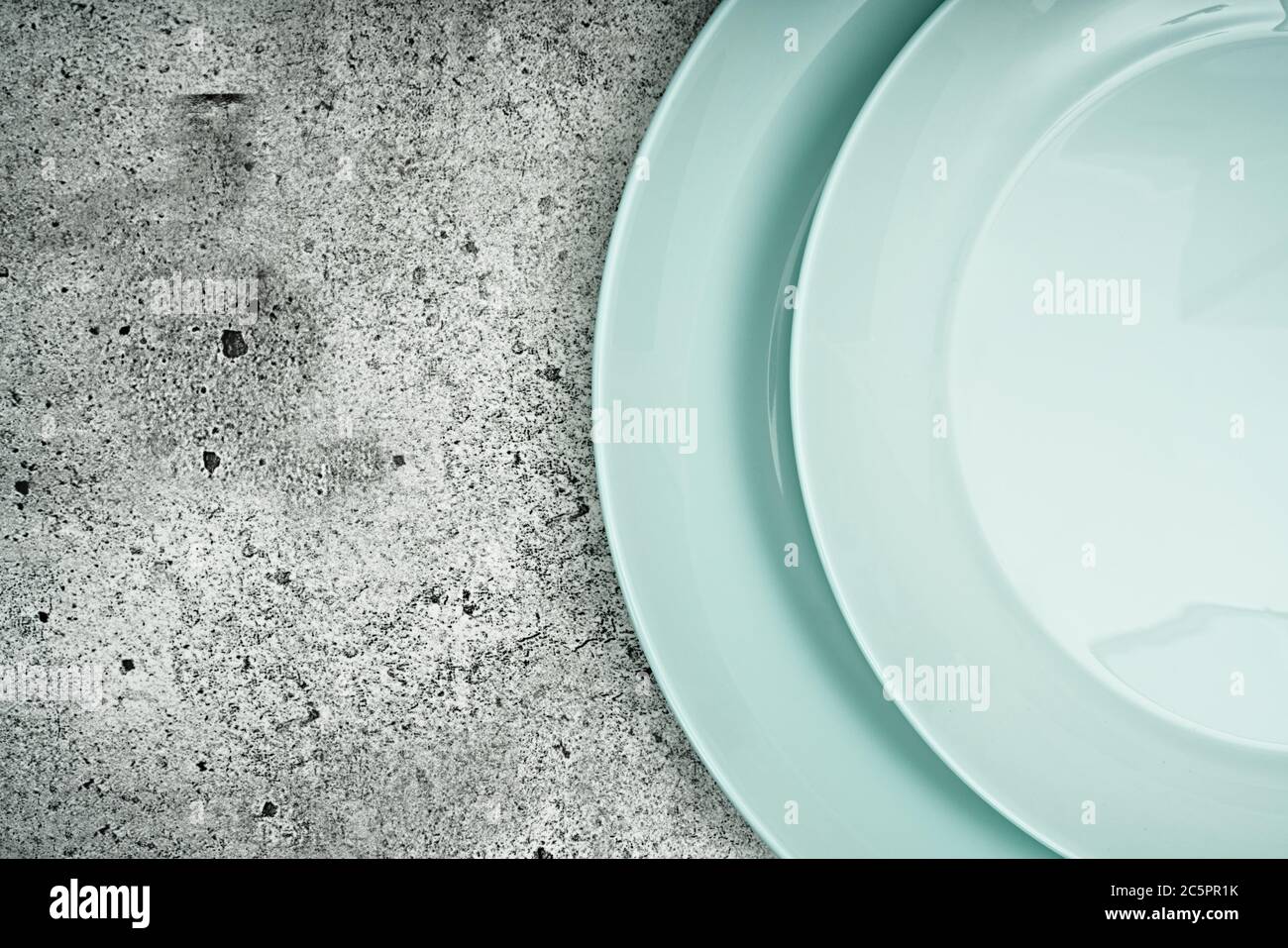 A stack of dishes on a light background. Glass set of dishes for the ...