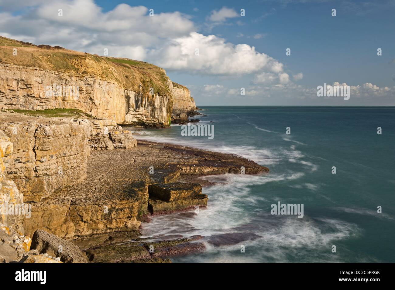 the rock ledge, waves and cliffs at Dancing Ledge on the Dorset coast ...