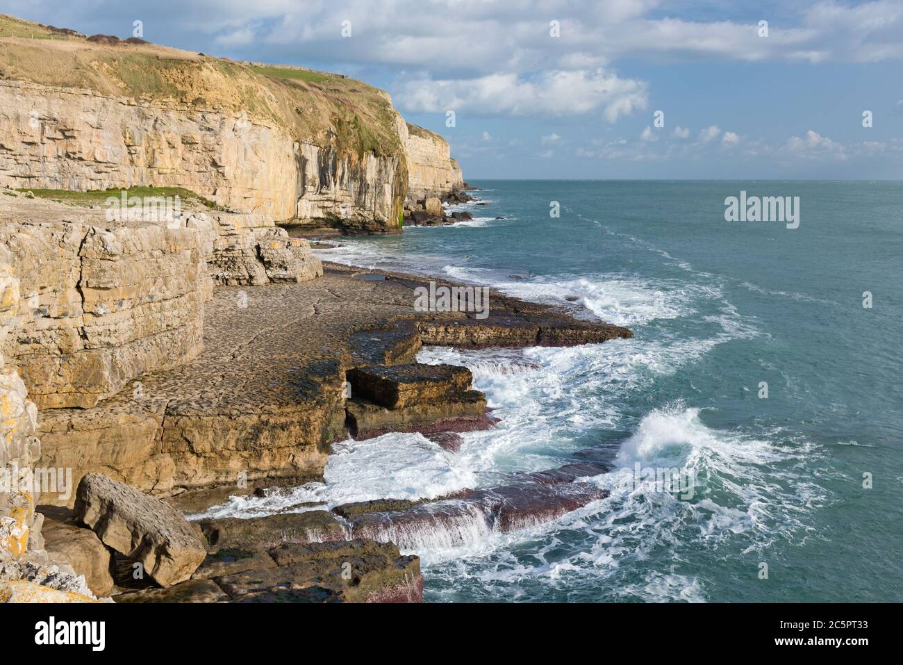 the rock ledge, waves and cliffs at Dancing Ledge on the Dorset coast ...