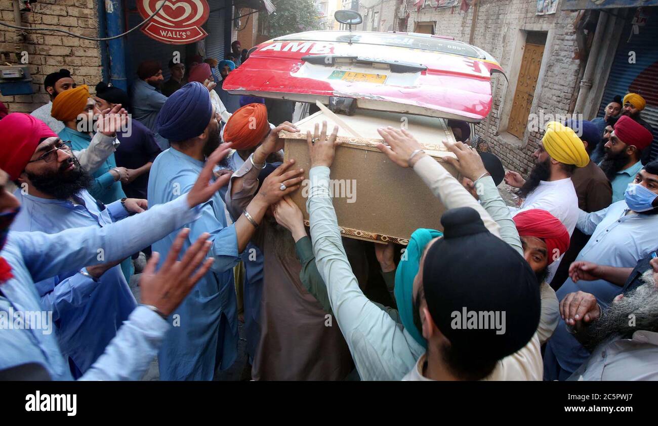 Members of Sikh community carry coffin of their relatives, who were ...