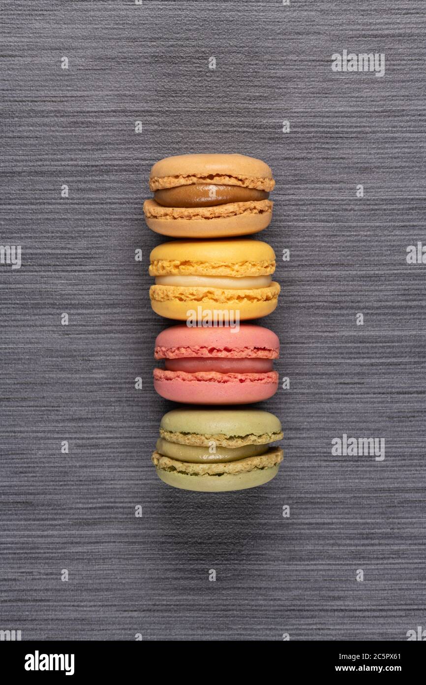 Four macaroonson grey vinyl background Stock Photo - Alamy