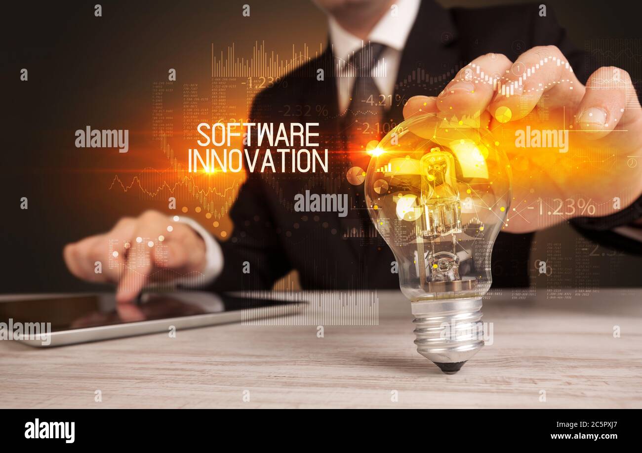 Businessman holding lightbulb with SOFTWARE INNOVATION inscription, Business technology concept ...