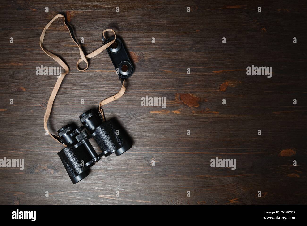 Old black military binocular on wood table background. Copy space for your text. Flat lay Stock ...