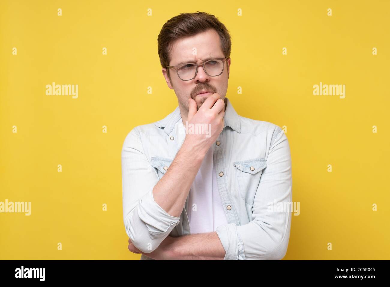 young caucasian man making a hard decision Stock Photo - Alamy