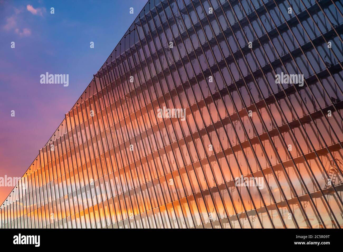 Reflection of the sunset sky in a glass facade of the building ...