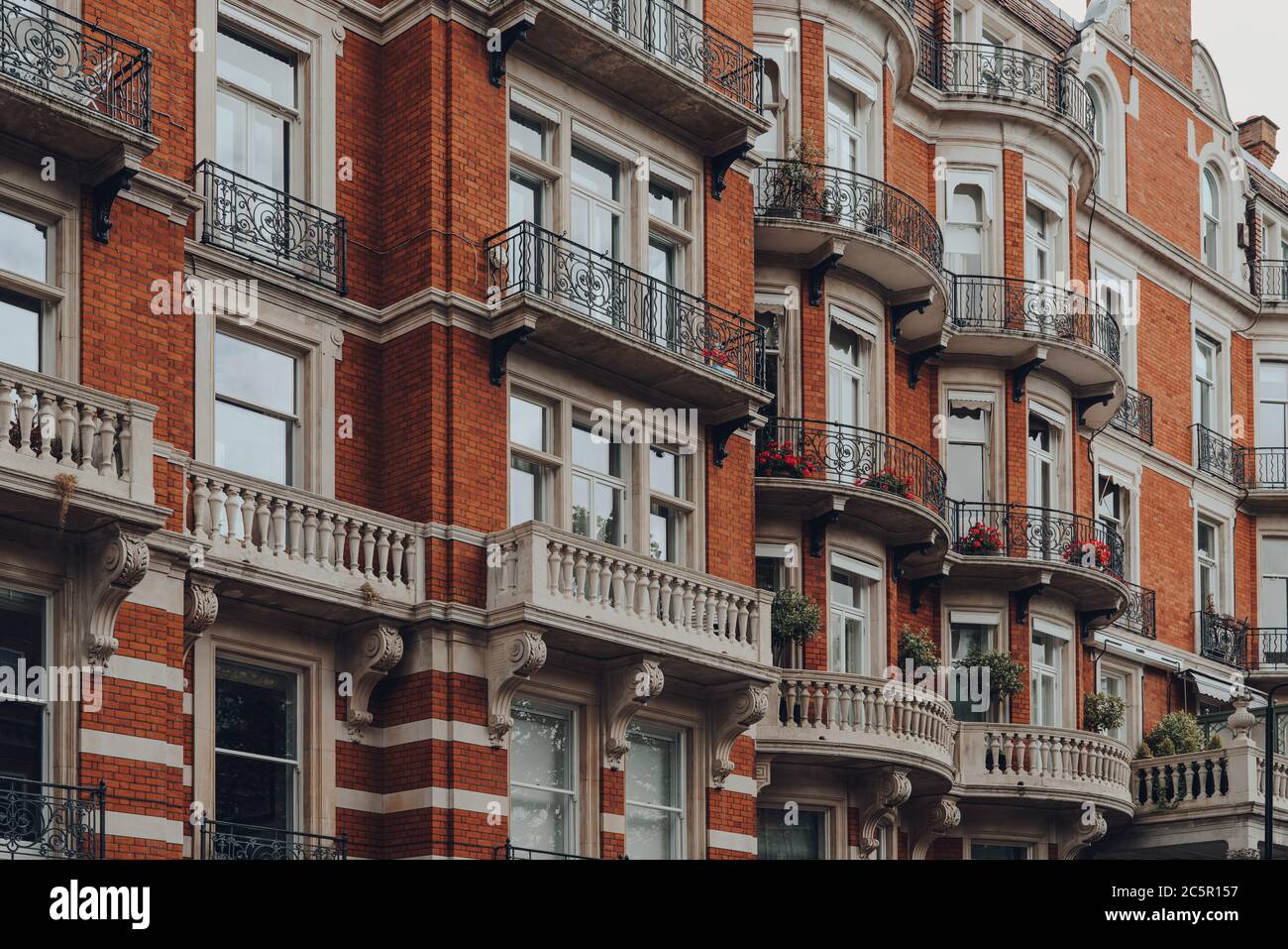 Exterior of a traditional red brick apartment block with balconies in ...